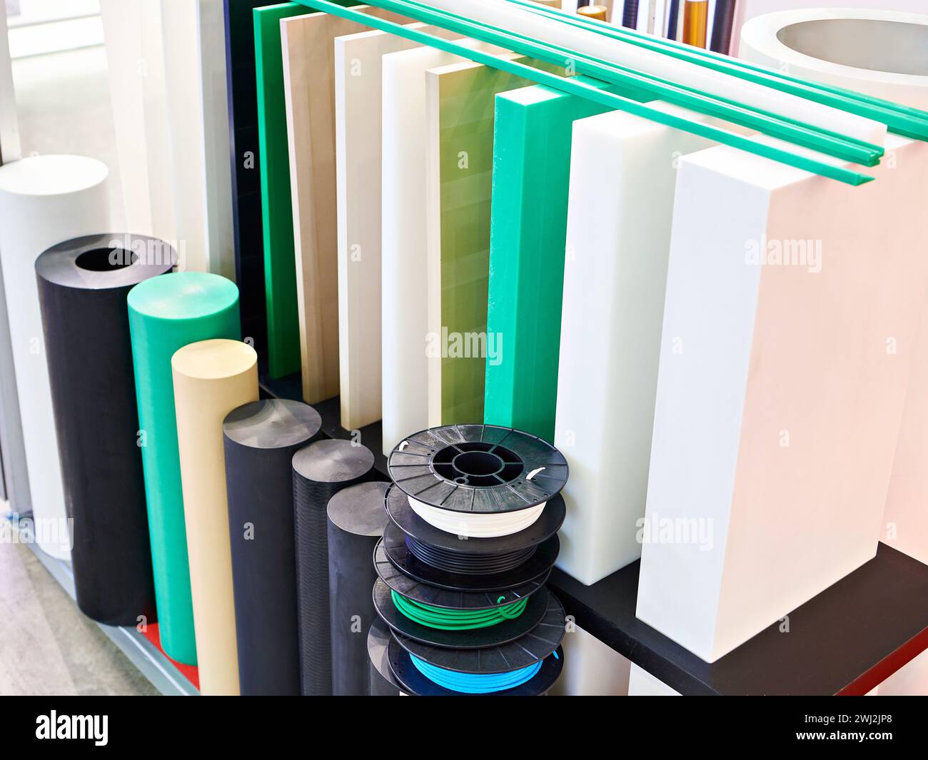 Pipes, rods and sheets of composite and plastic materials in store of ...