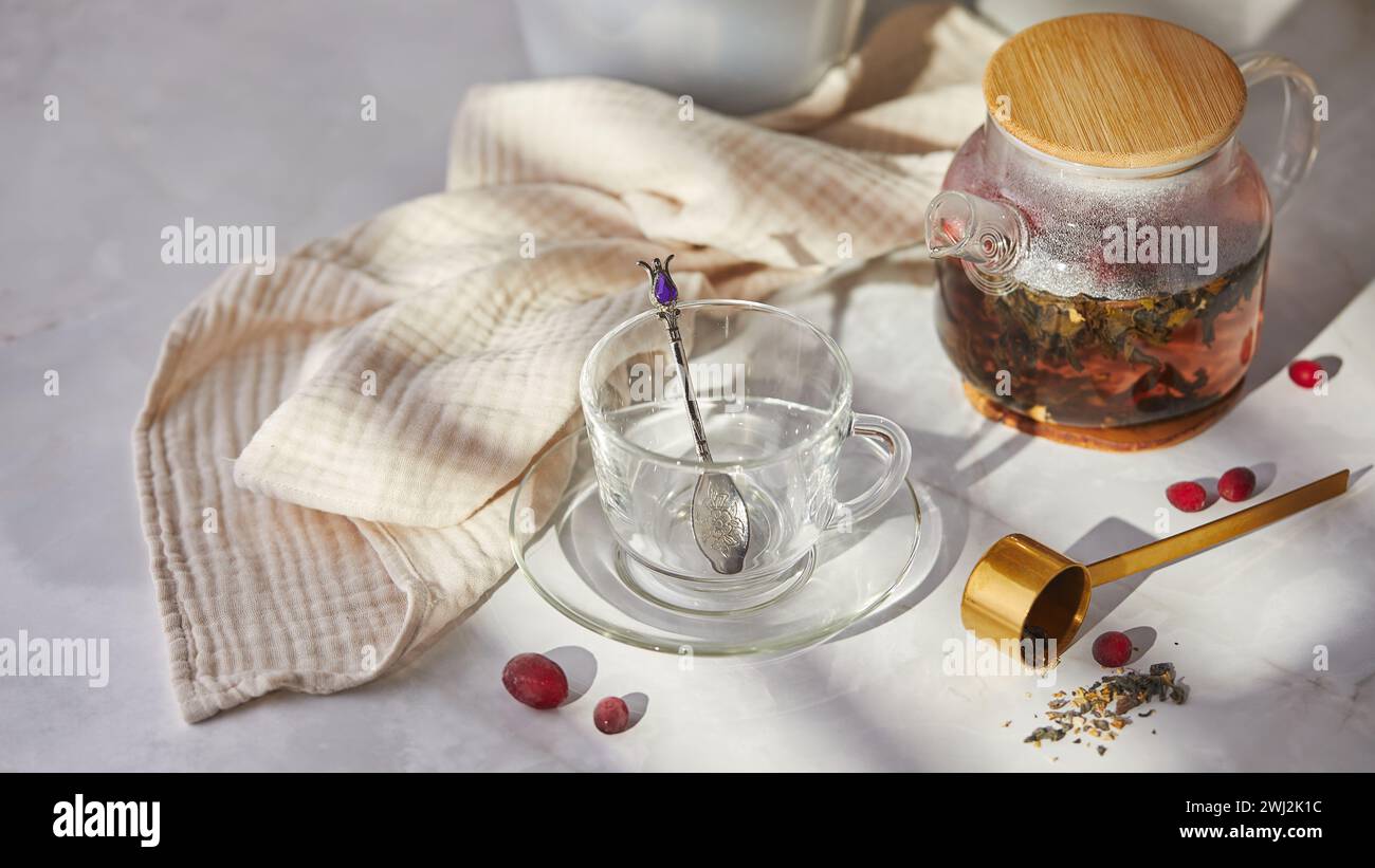 Fruit and berry tea. Preparation. Empty glass teapot and cup on the ...