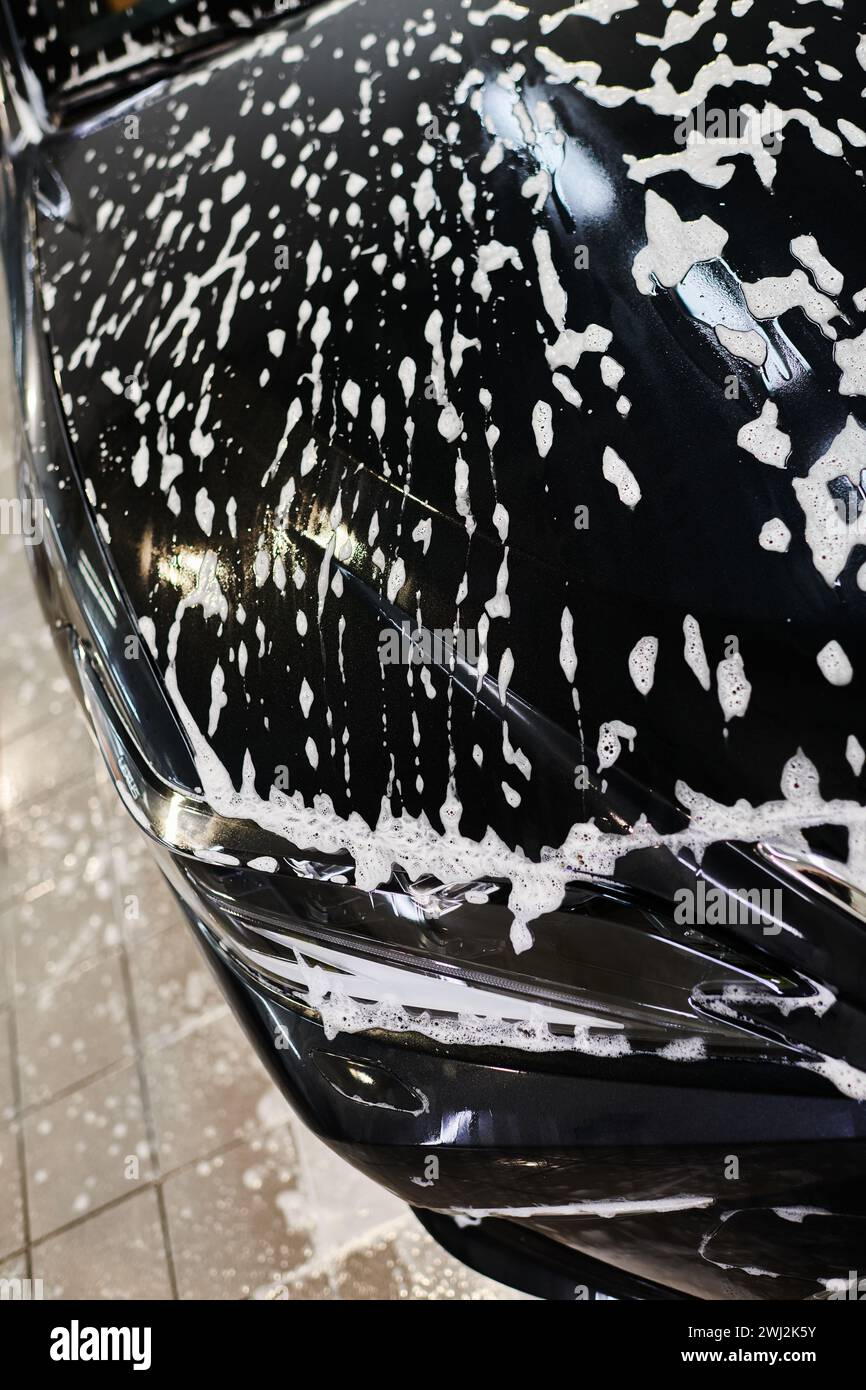 object photo of shiny and soapy black modern automobile during car ...