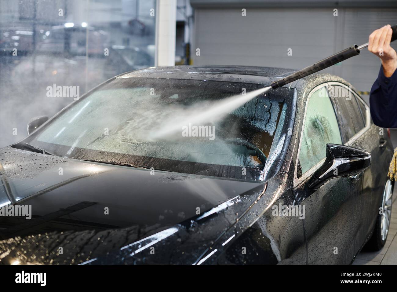 cropped view of devoted professional serviceman in uniform washing ...