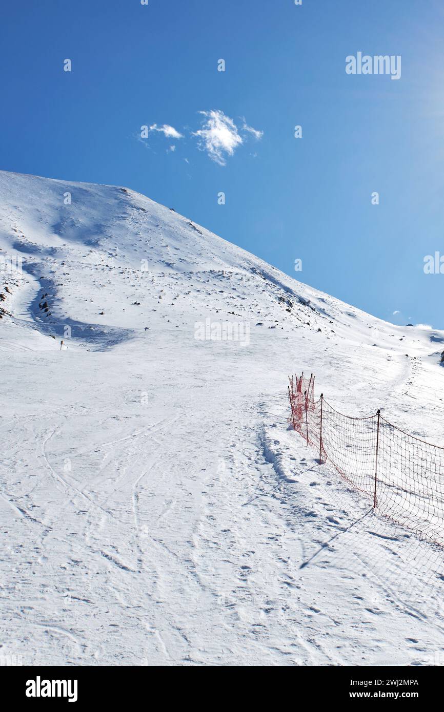 Winter mountains landscape at sunny day. Empty piste at ski resort ...