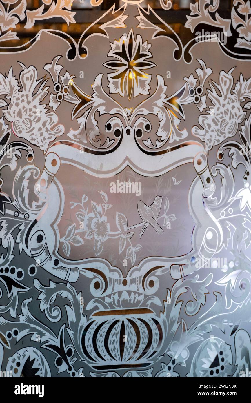 Elaborate etched glass on the window of a traditional English pub on ...