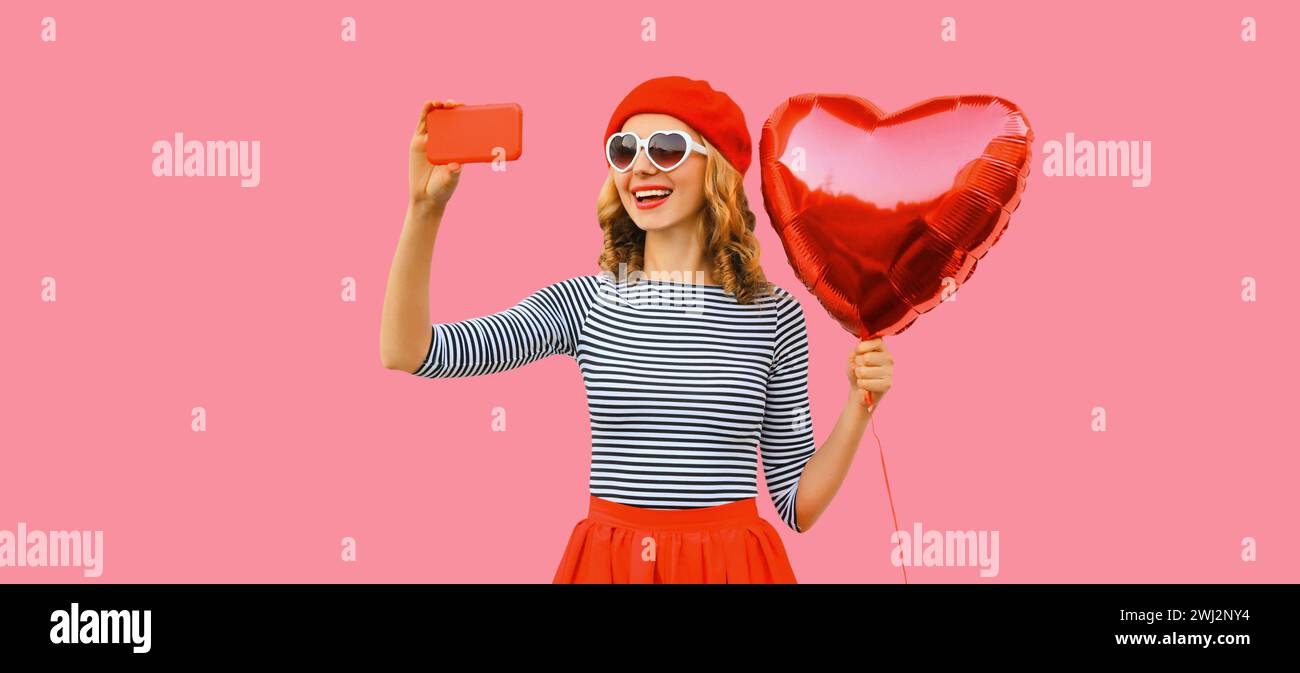 happy smiling young woman taking selfie with mobile phone holding red ...