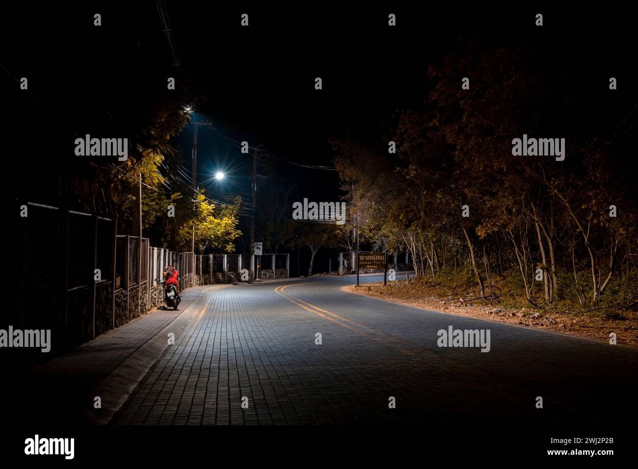 straight empty street at night with lanterns Stock Photo - Alamy