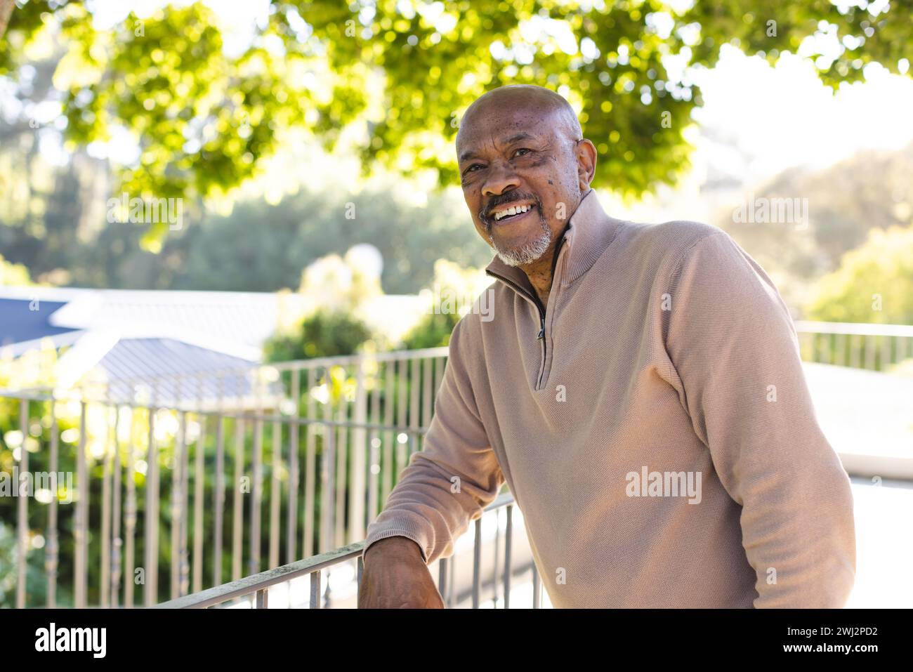 Happy african american senior man on sunny terrace Stock Photo - Alamy
