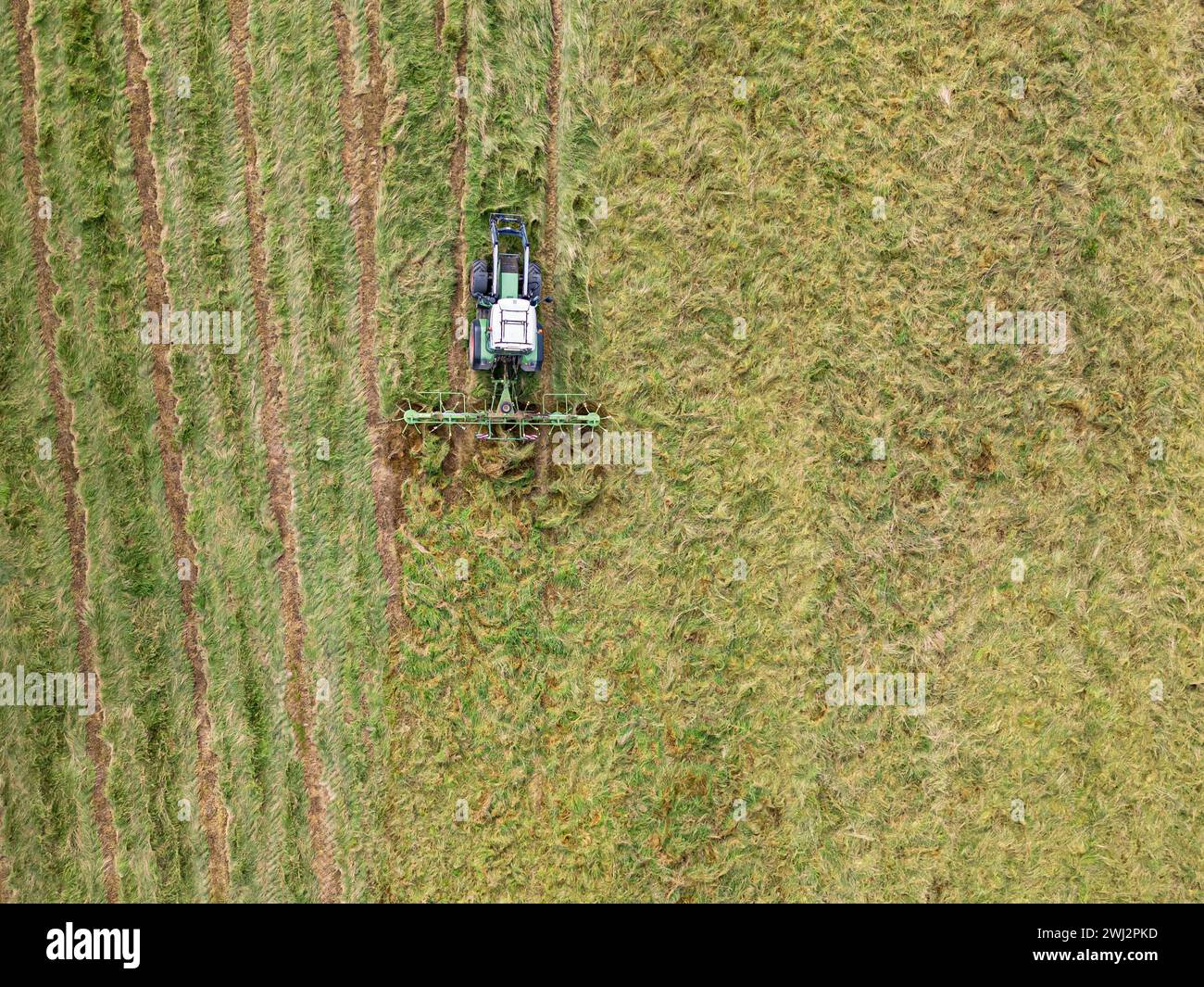 UK farming aerial photography of John Deere tractor haymaking Stock ...