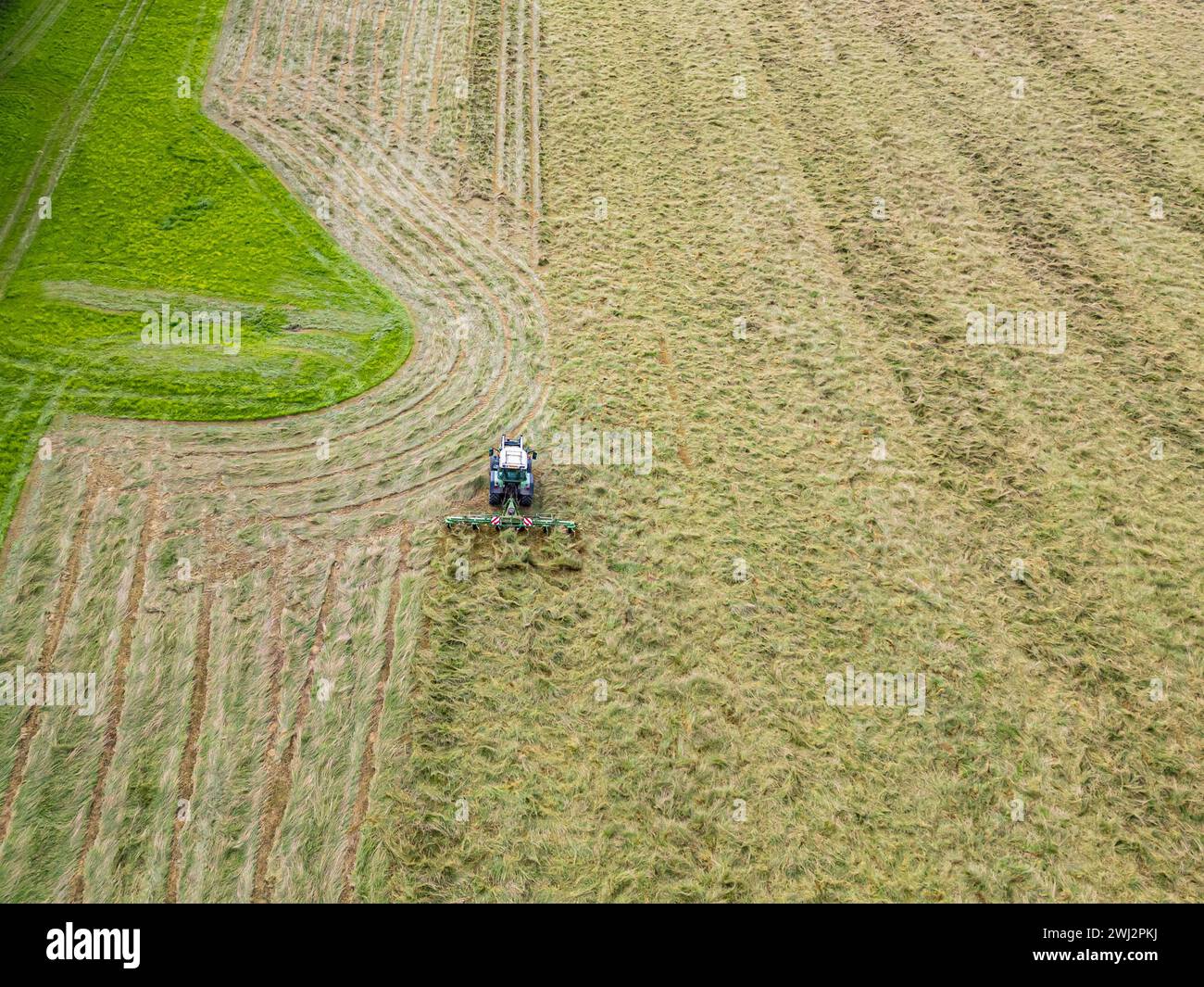 UK farming aerial photography of John Deere tractor haymaking Stock ...