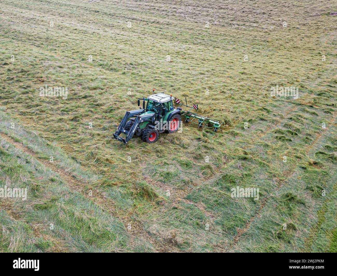 UK farming aerial photography of John Deere tractor haymaking Stock ...