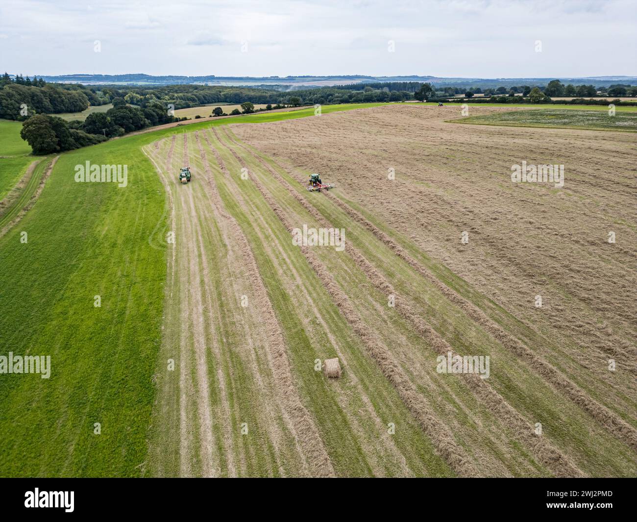 UK farming aerial photography of John Deere tractor haymaking Stock ...