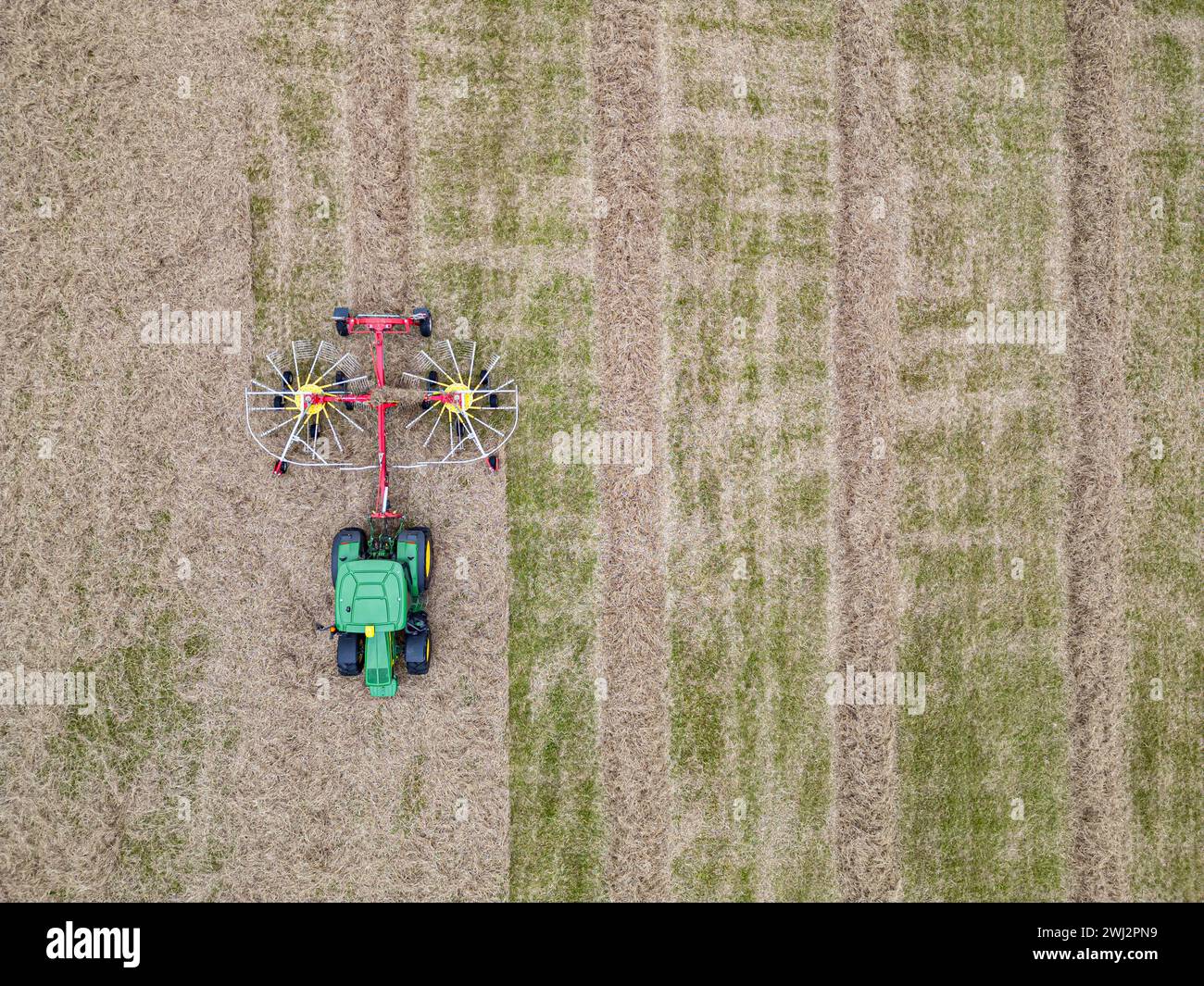 UK farming aerial photography of John Deere tractor haymaking Stock ...