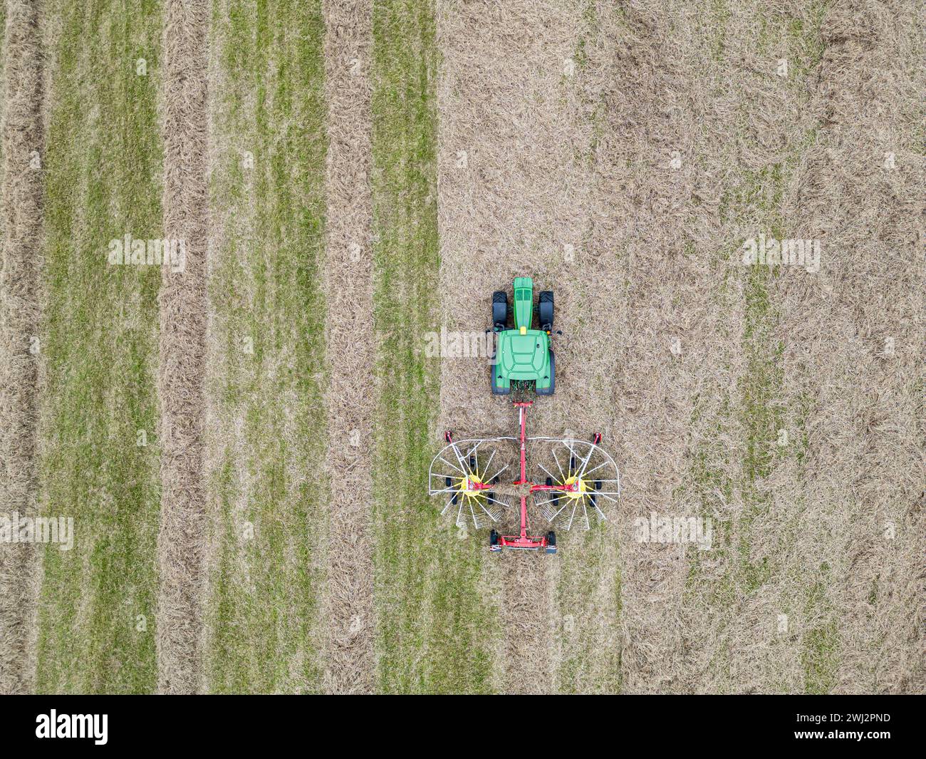 UK farming aerial photography of John Deere tractor haymaking Stock ...