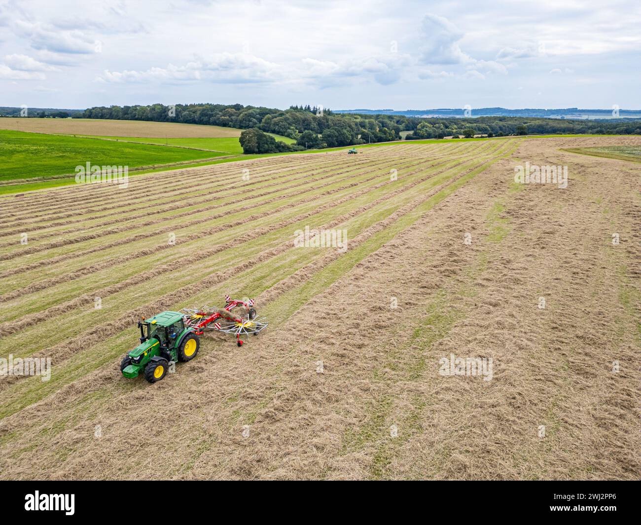 UK farming aerial photography of John Deere tractor haymaking Stock ...