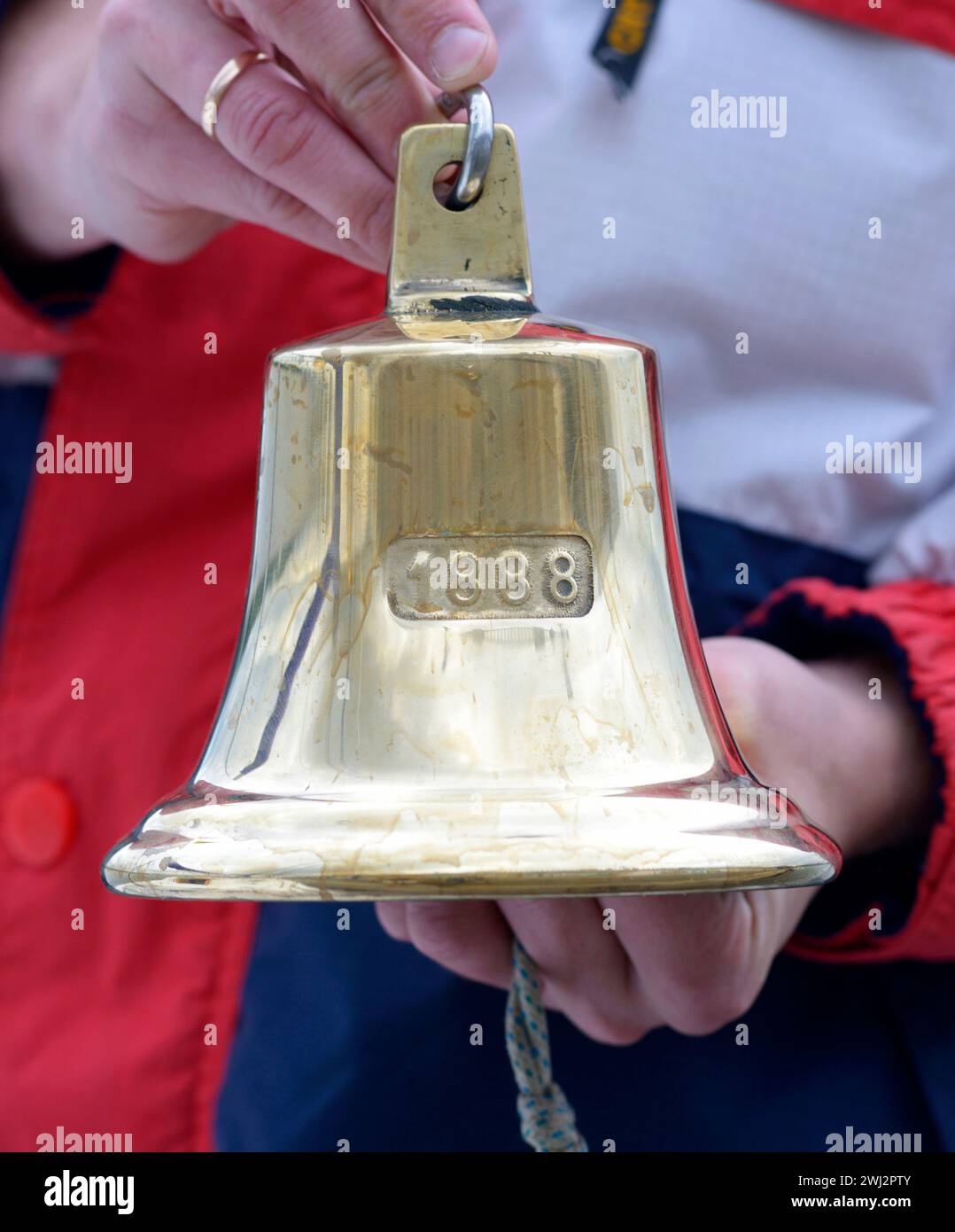 Man hands hold vintage ship's bell made in 1888 Stock Photo - Alamy