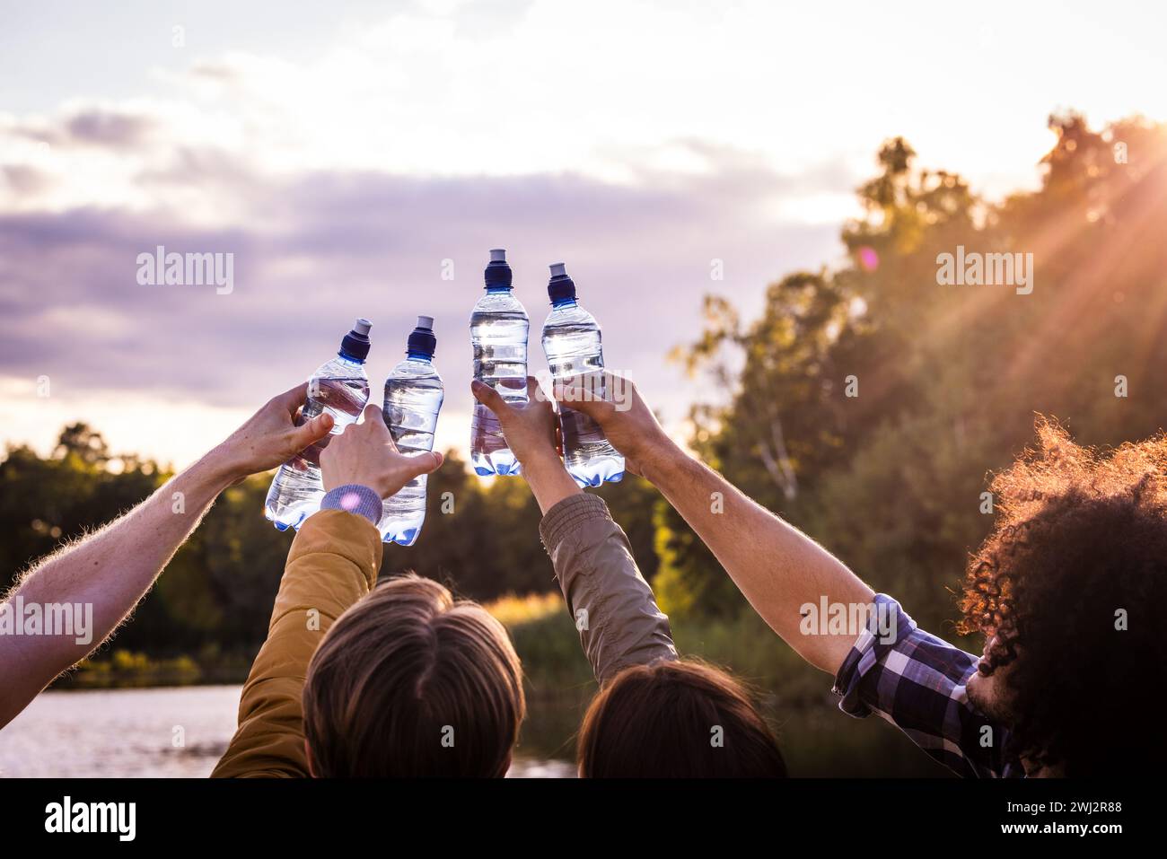 Hydration Celebration: Toasting with Water Bottles Stock Photo - Alamy