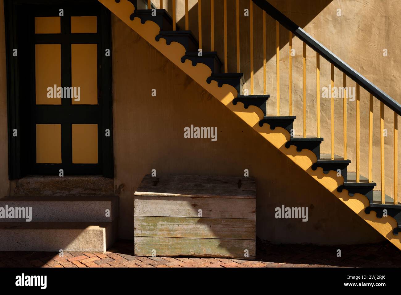Abstract photography of a door under a staircase in shadows and ...