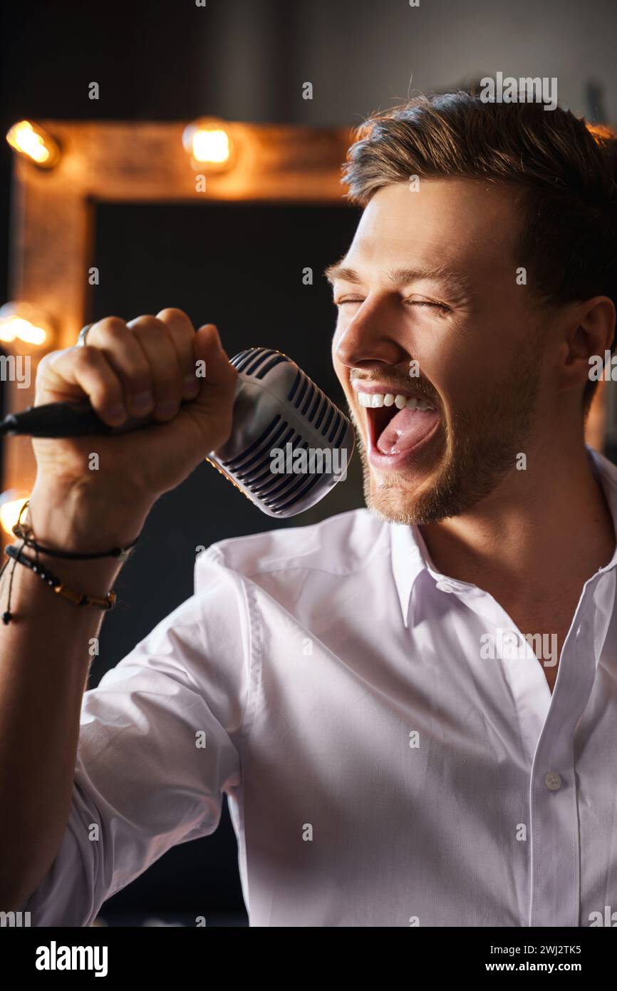 Young man singing with microphone hi-res stock photography and images - Alamy