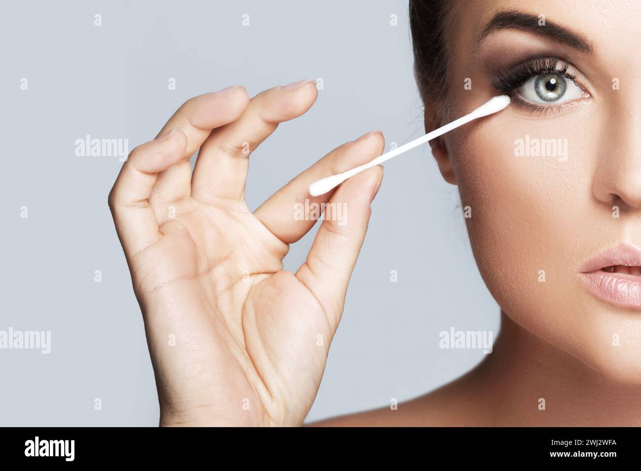 Female face with a cotton swab beside beautiful eye Stock Photo - Alamy