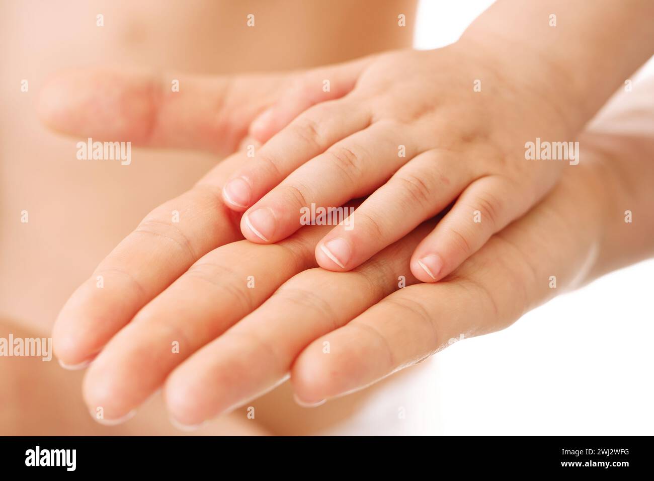 Little child placing hand on his mother palm Stock Photo - Alamy