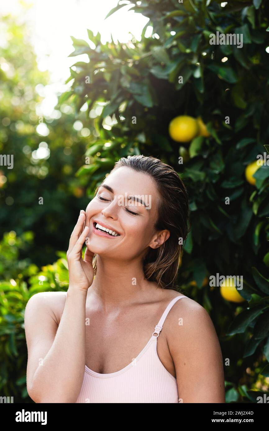 Portrait of beautiful woman with smooth skin against lemon trees Stock ...