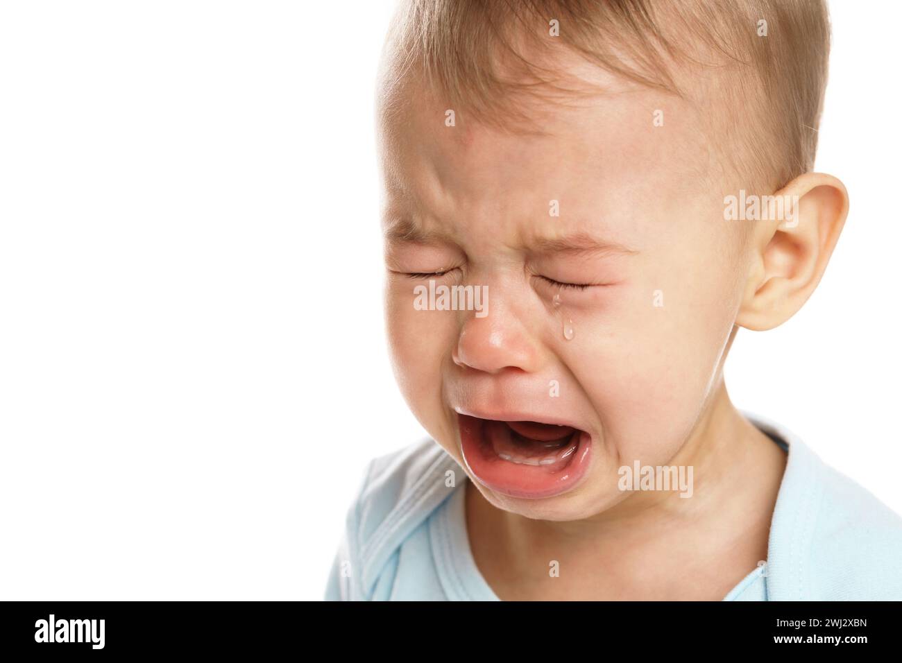 Closeuo shot of face of crying little boy in romper Stock Photo - Alamy