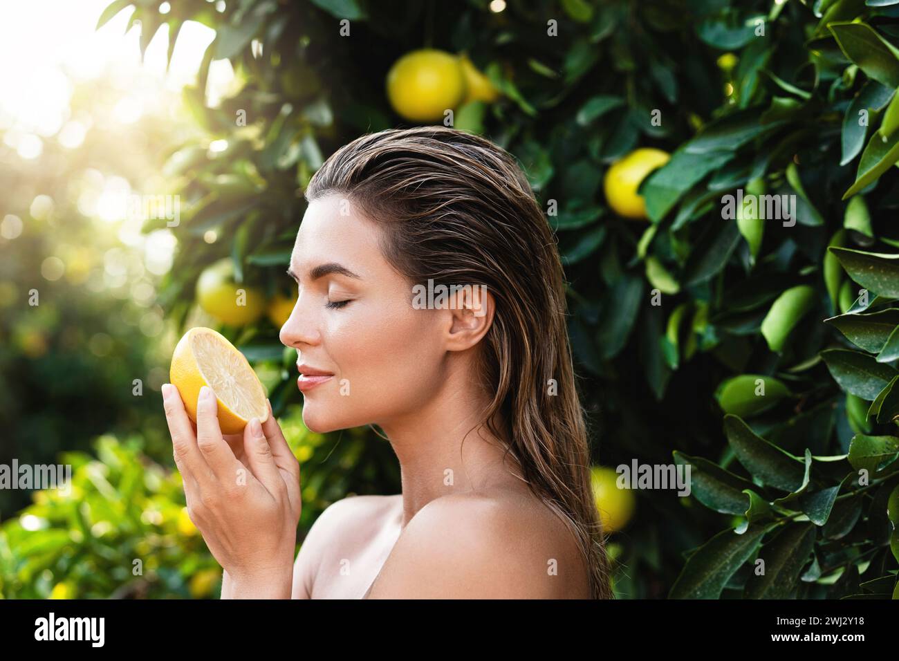Beautiful woman with smooth skin with a lemon fruit in her hands Stock ...