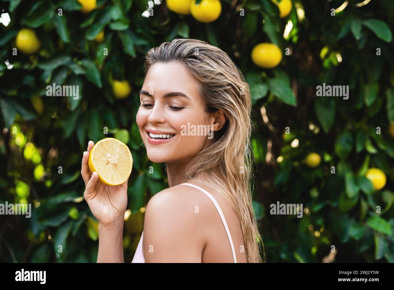 Beautiful woman with smooth skin with a lemon fruit in her hands Stock ...