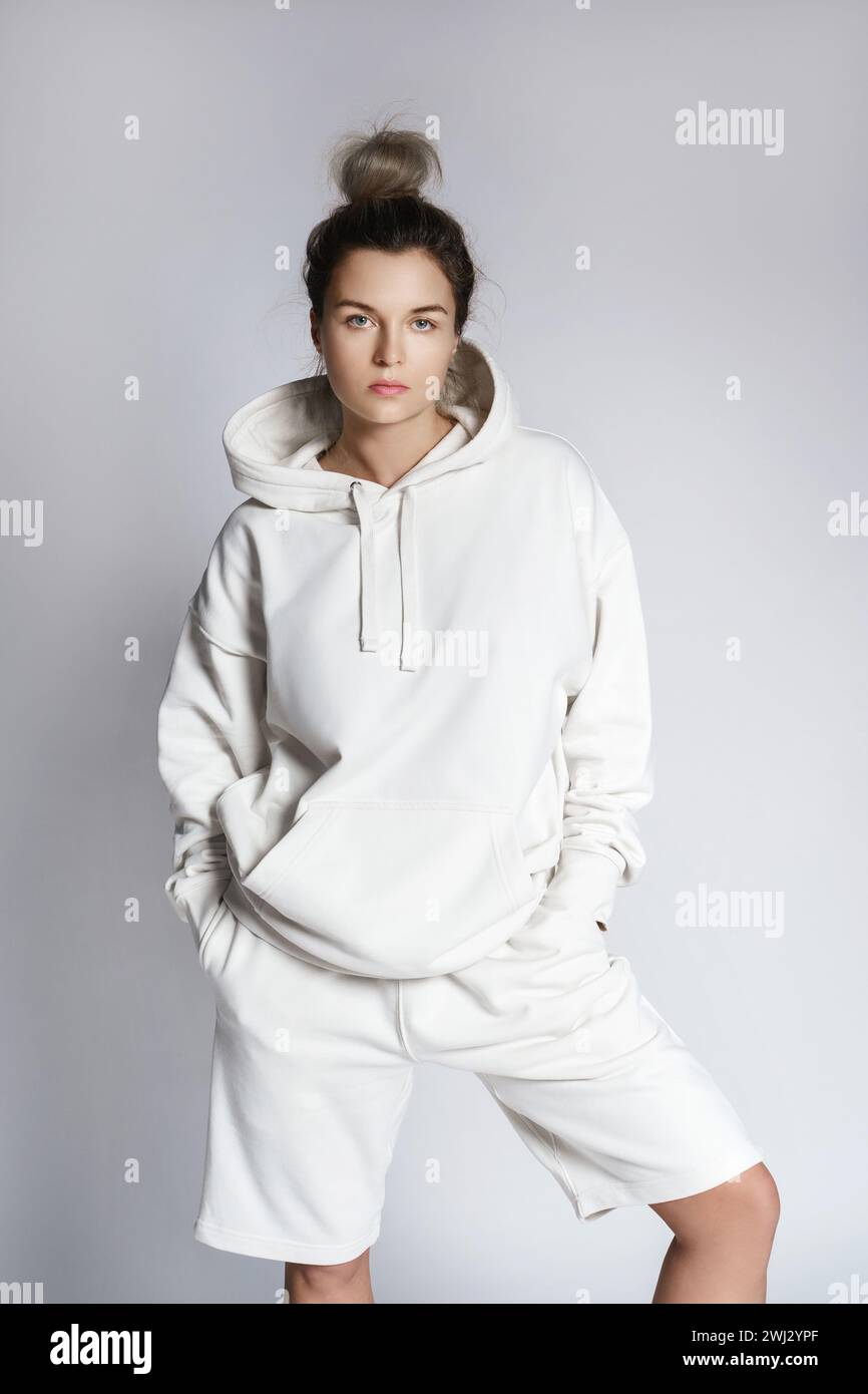 Young woman stylish woman wearing white hoodie Stock Photo - Alamy