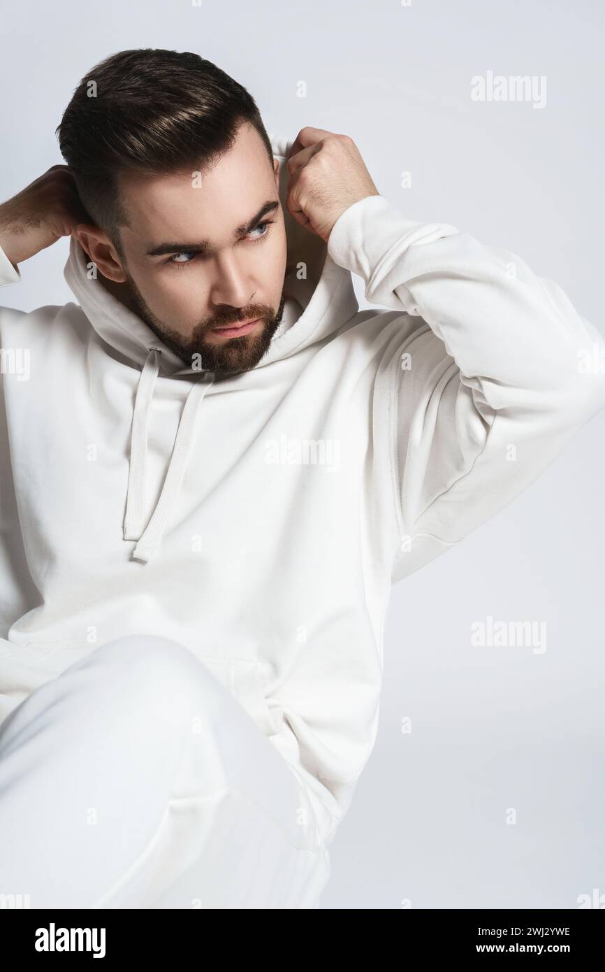 Young man wearing hoodie sitting hi-res stock photography and images ...