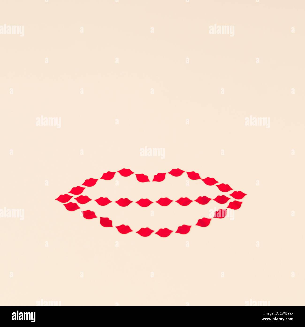 Creative love layout of lips shape made with red lips confetti on light ...