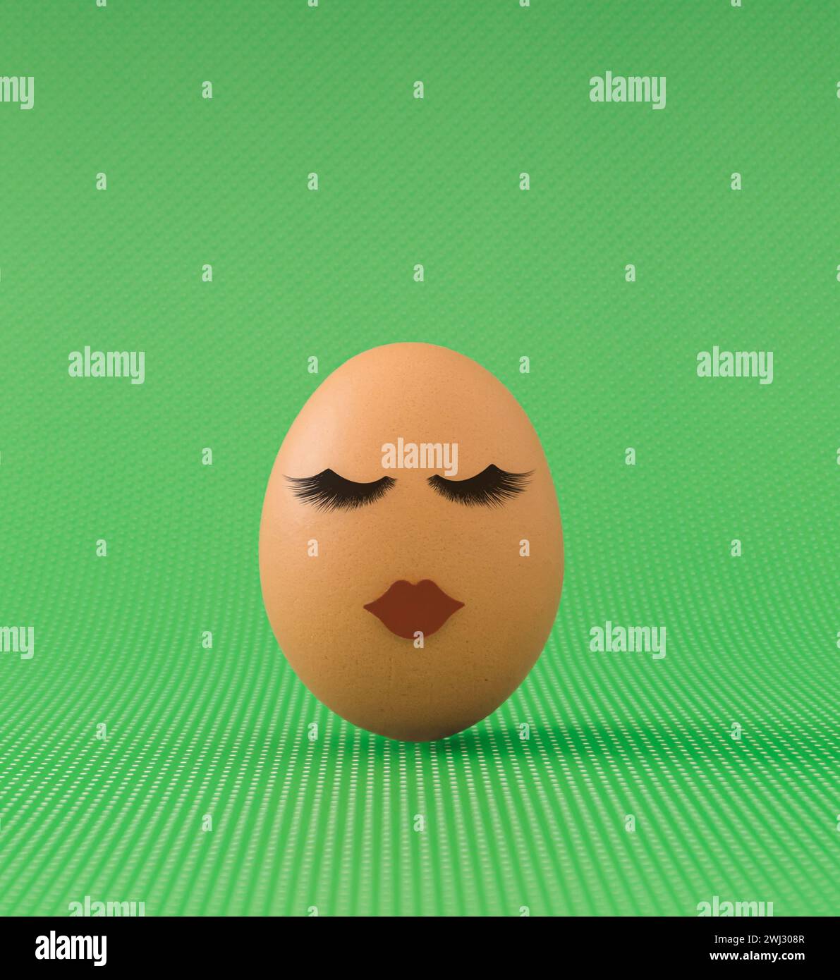 Easter egg with red lips and eyelashes on green background. Minimal ...