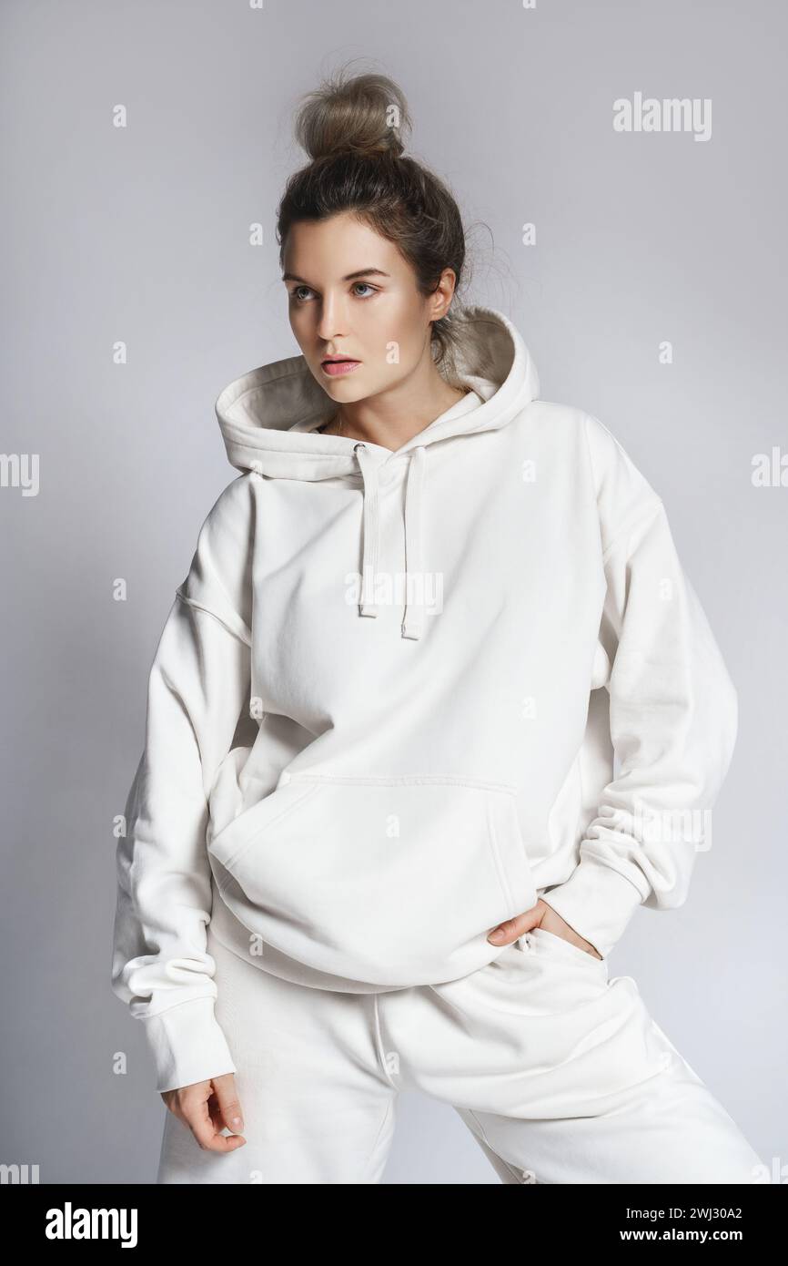 Young woman stylish woman wearing white hoodie Stock Photo - Alamy