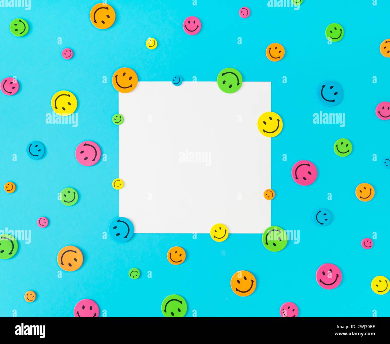 Colorful pattern composition made with smiley face stickers on blue ...
