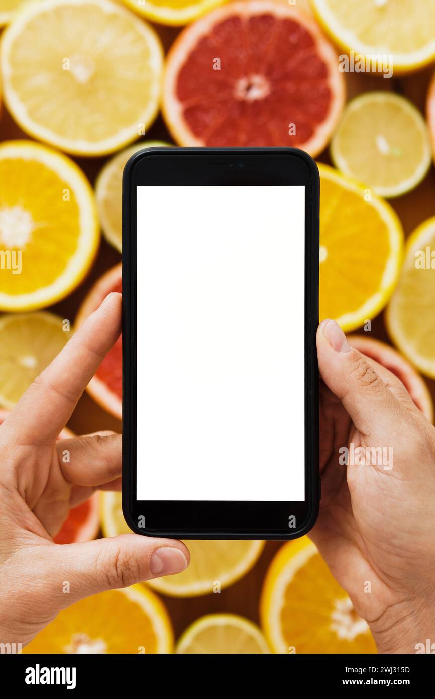 Female hand holding smartphone with empty screen for your design ...