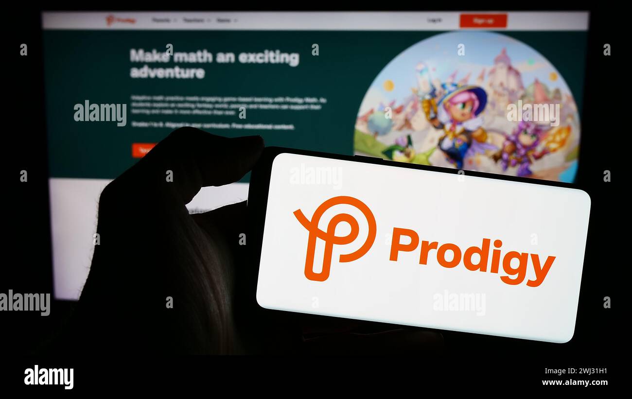 Person holding mobile phone with logo of American online learning company Prodigy Education Inc ...