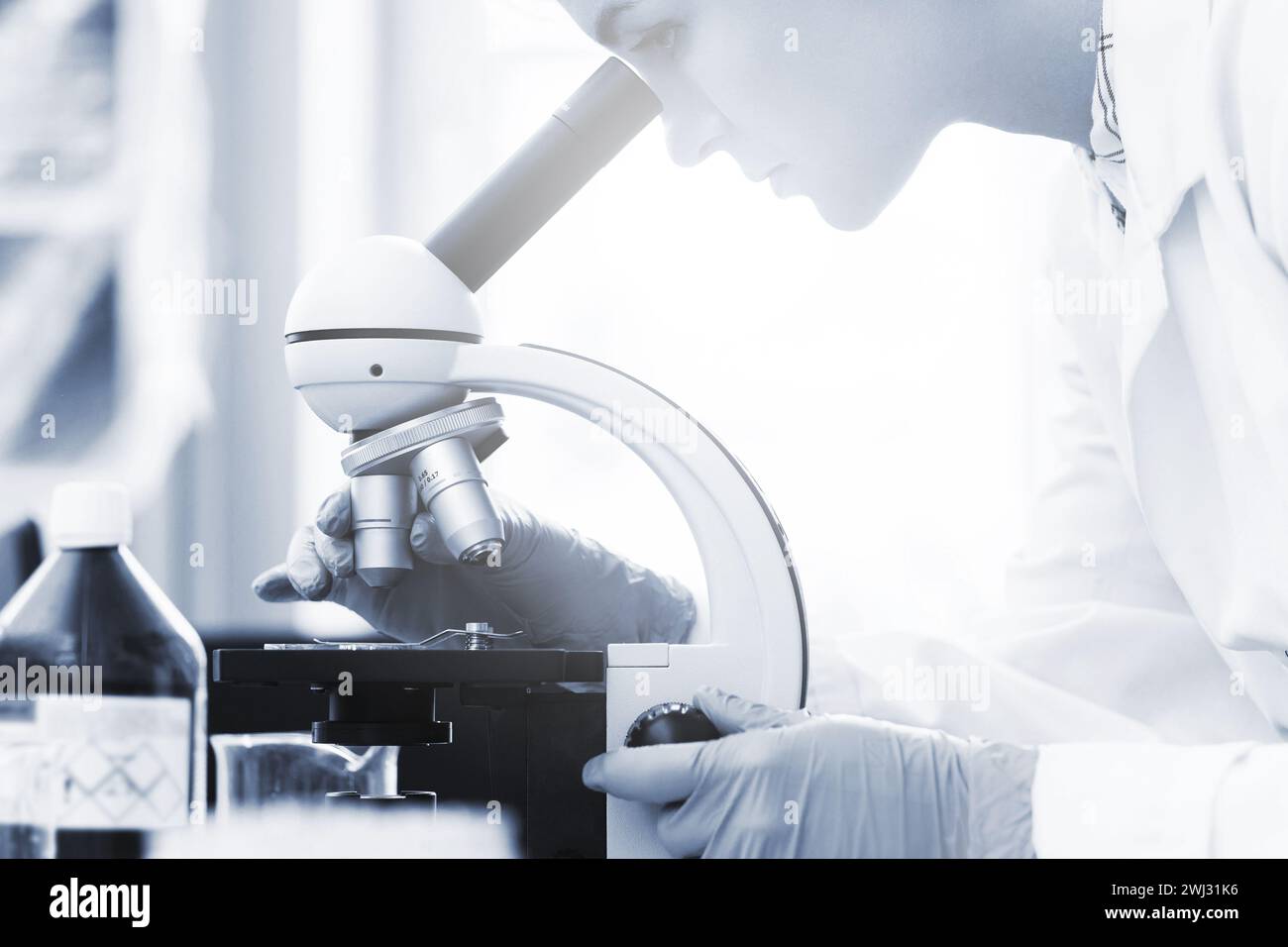 Woman scientist is using microscope in a laboratory during research Stock Photo - Alamy
