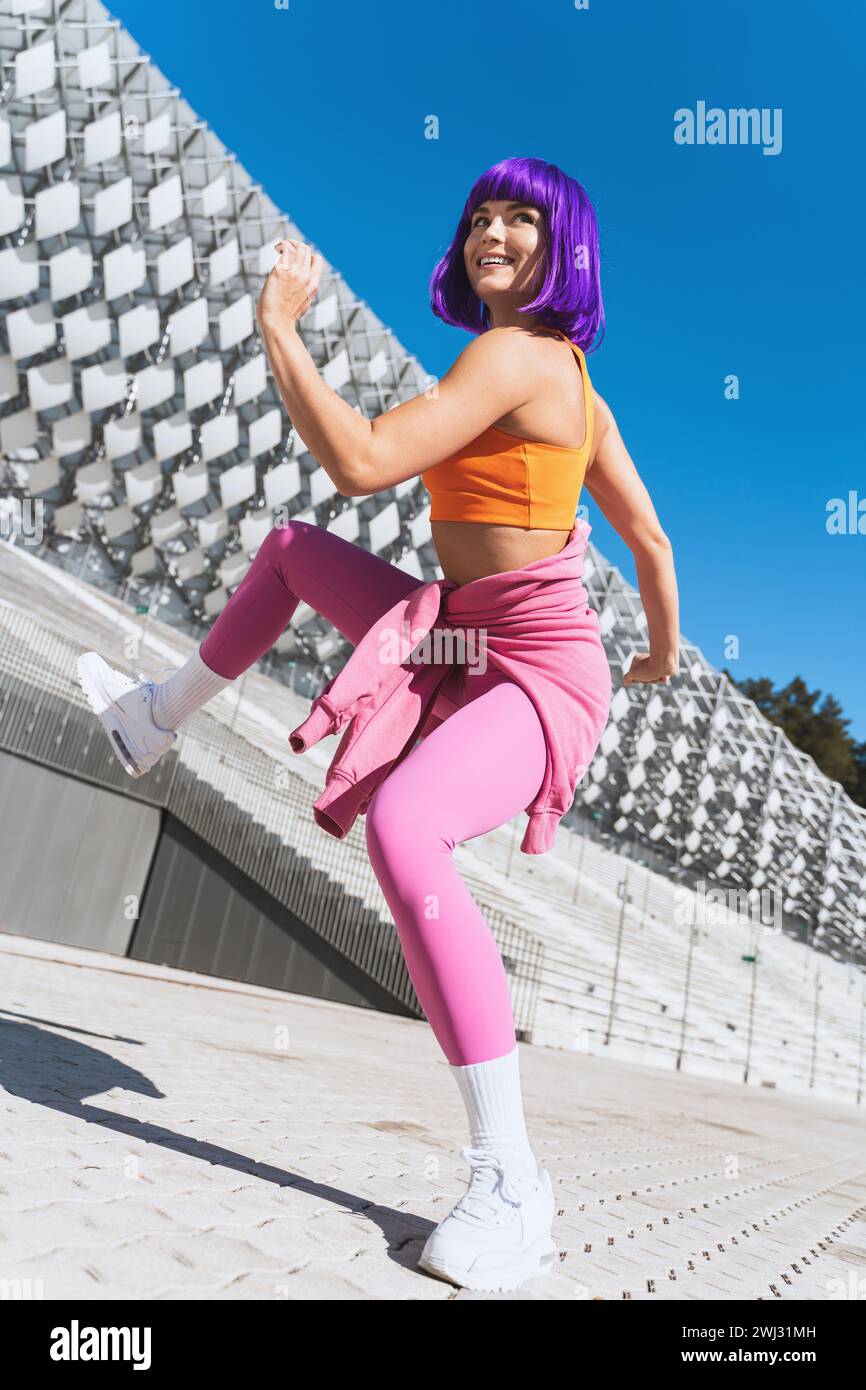 Carefree active woman dancer wearing colorful sportswear having fun on ...