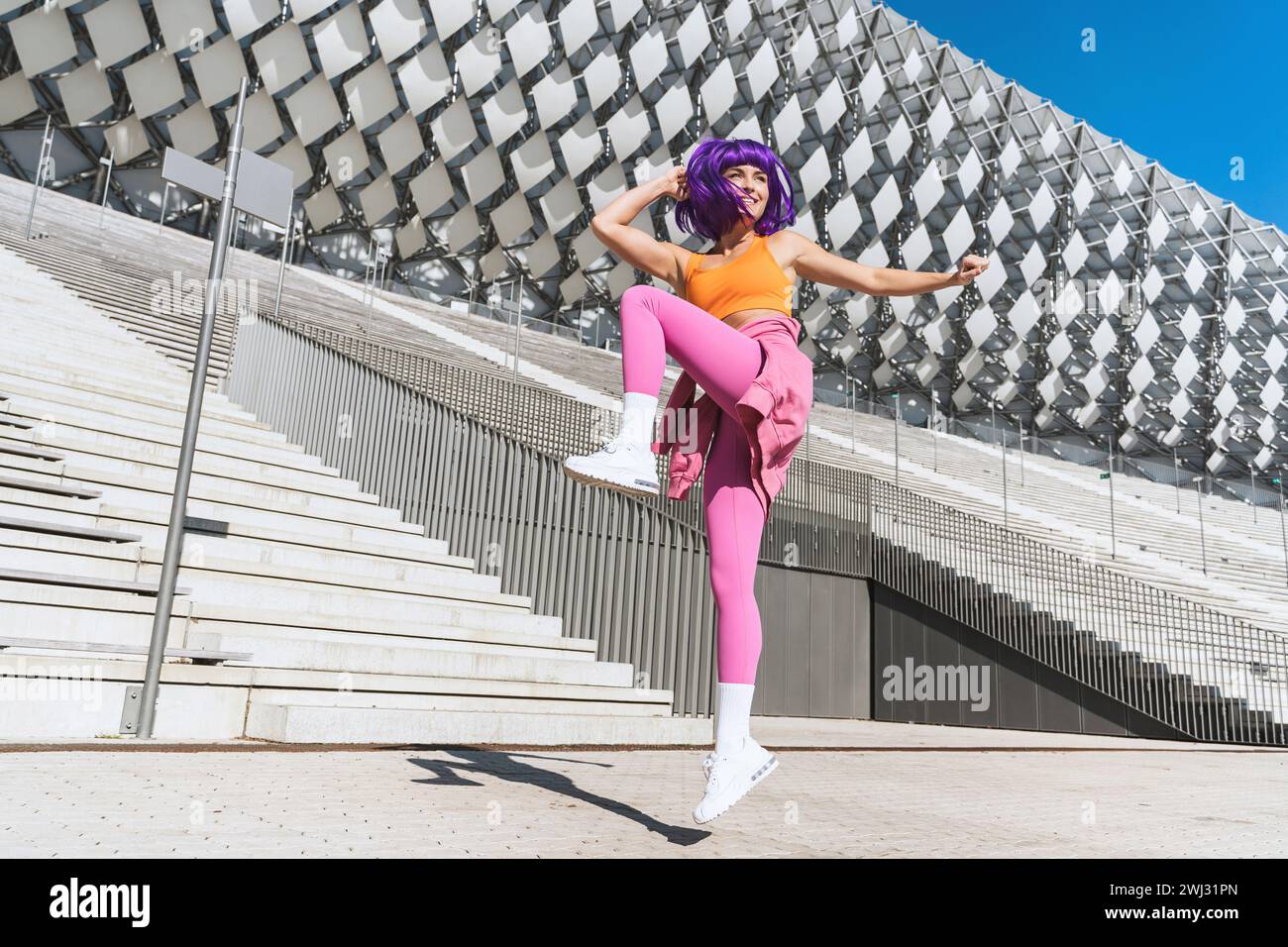 Carefree active woman dancer wearing colorful sportswear having fun on ...