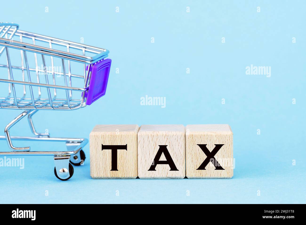 wood cube with word TAX. cart. Concept of taxes paid by individuals and ...