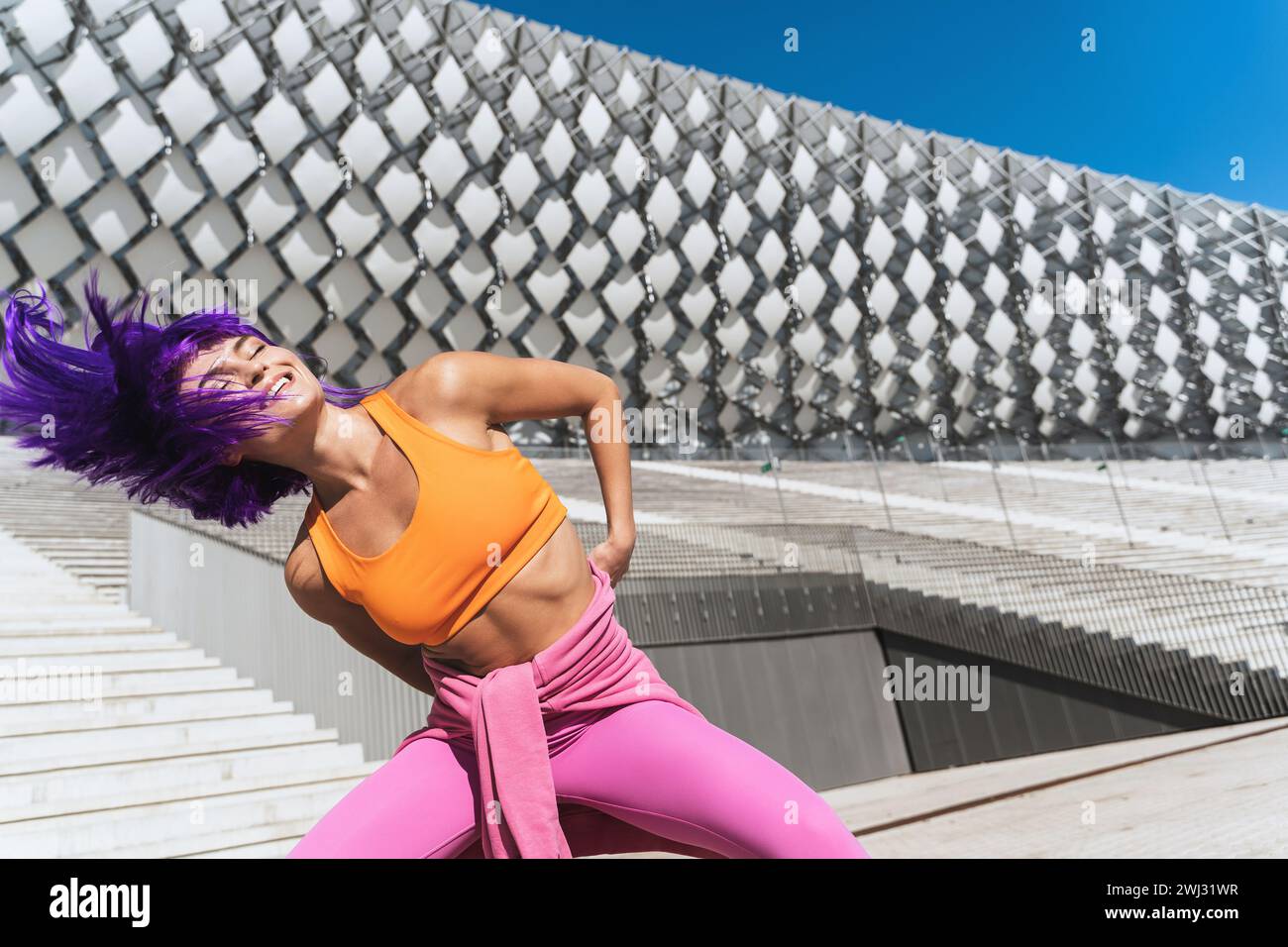 Carefree active woman dancer wearing colorful sportswear having fun on ...
