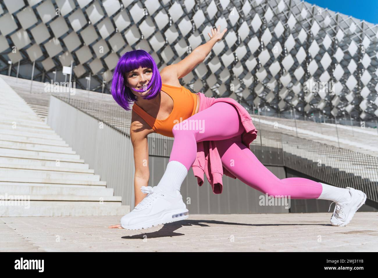 Carefree active woman dancer wearing colorful sportswear having fun on ...