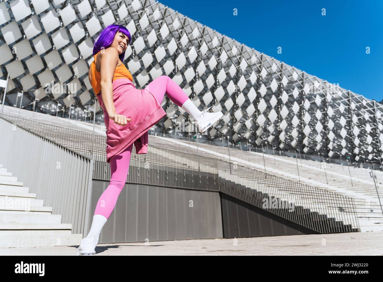 Carefree active woman dancer wearing colorful sportswear having fun on ...