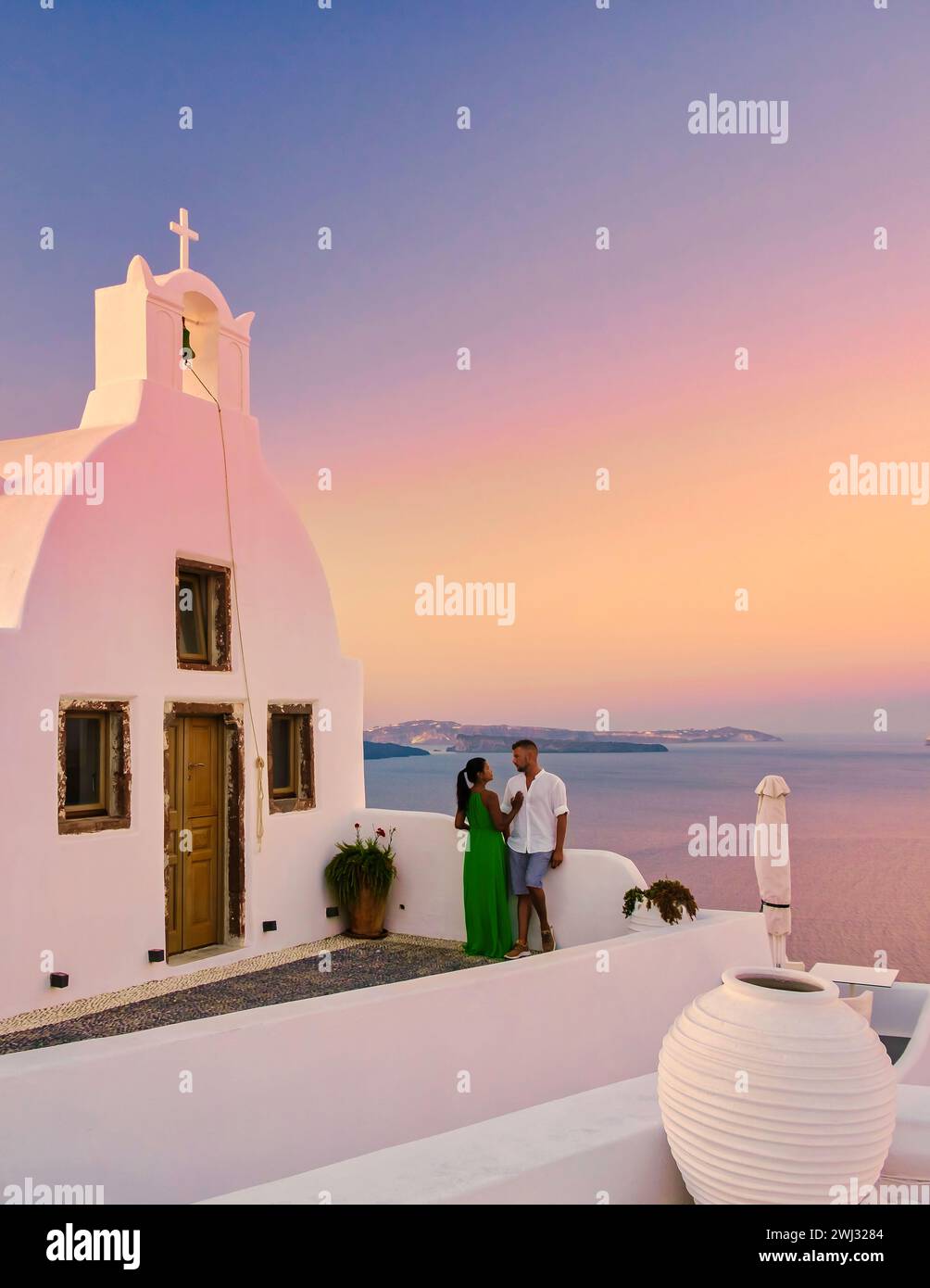 Couple hugging and kissing on a romantic vacation in Santorini Greece ...