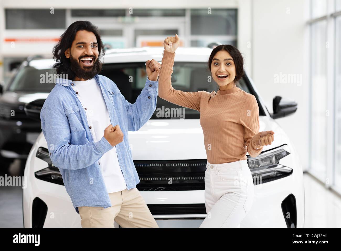 Indian Couple Celebrating Buying New Car, Dancing In Dealership Office ...