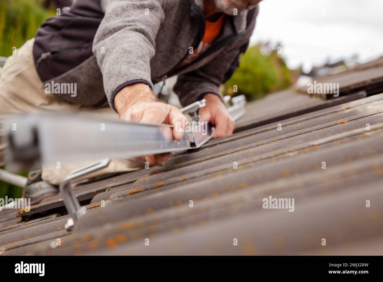 Roofer, worker on the rooftop. Roofing work. Solar Cell Installation ...