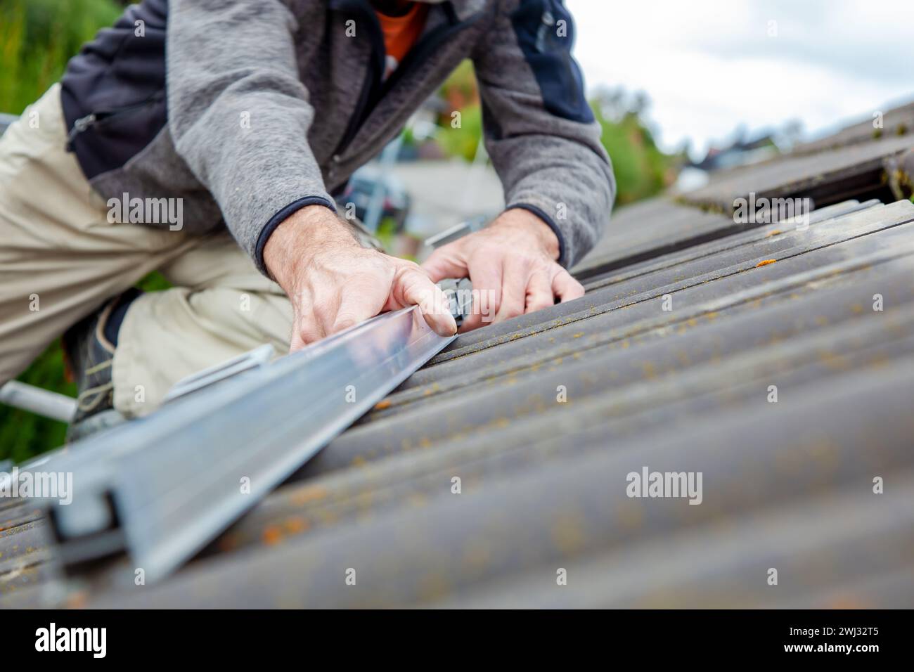 Roofer, worker on the rooftop. Roofing work. Solar Cell Installation ...