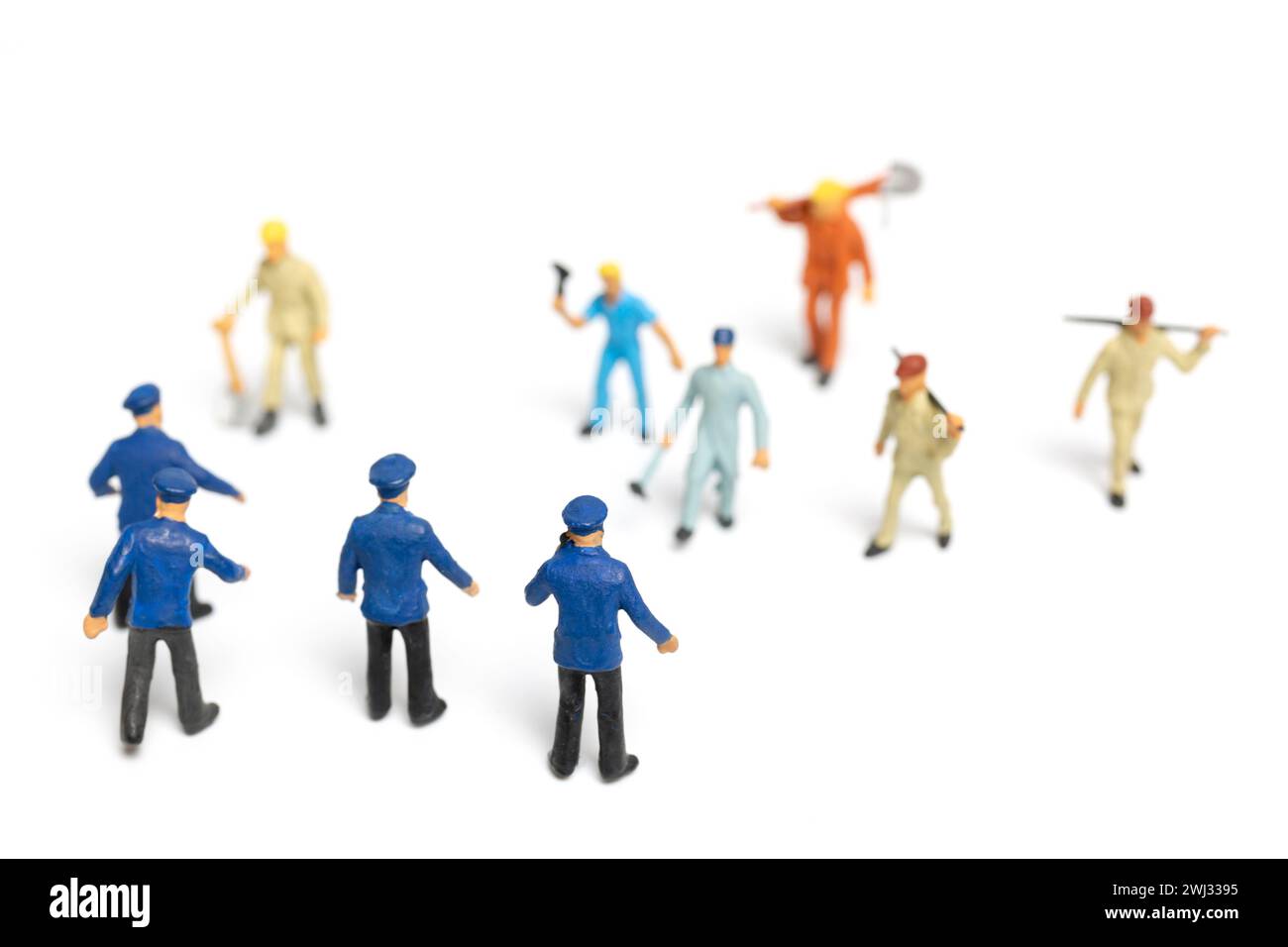 Miniature people : Police and an angry mob on white background Stock ...