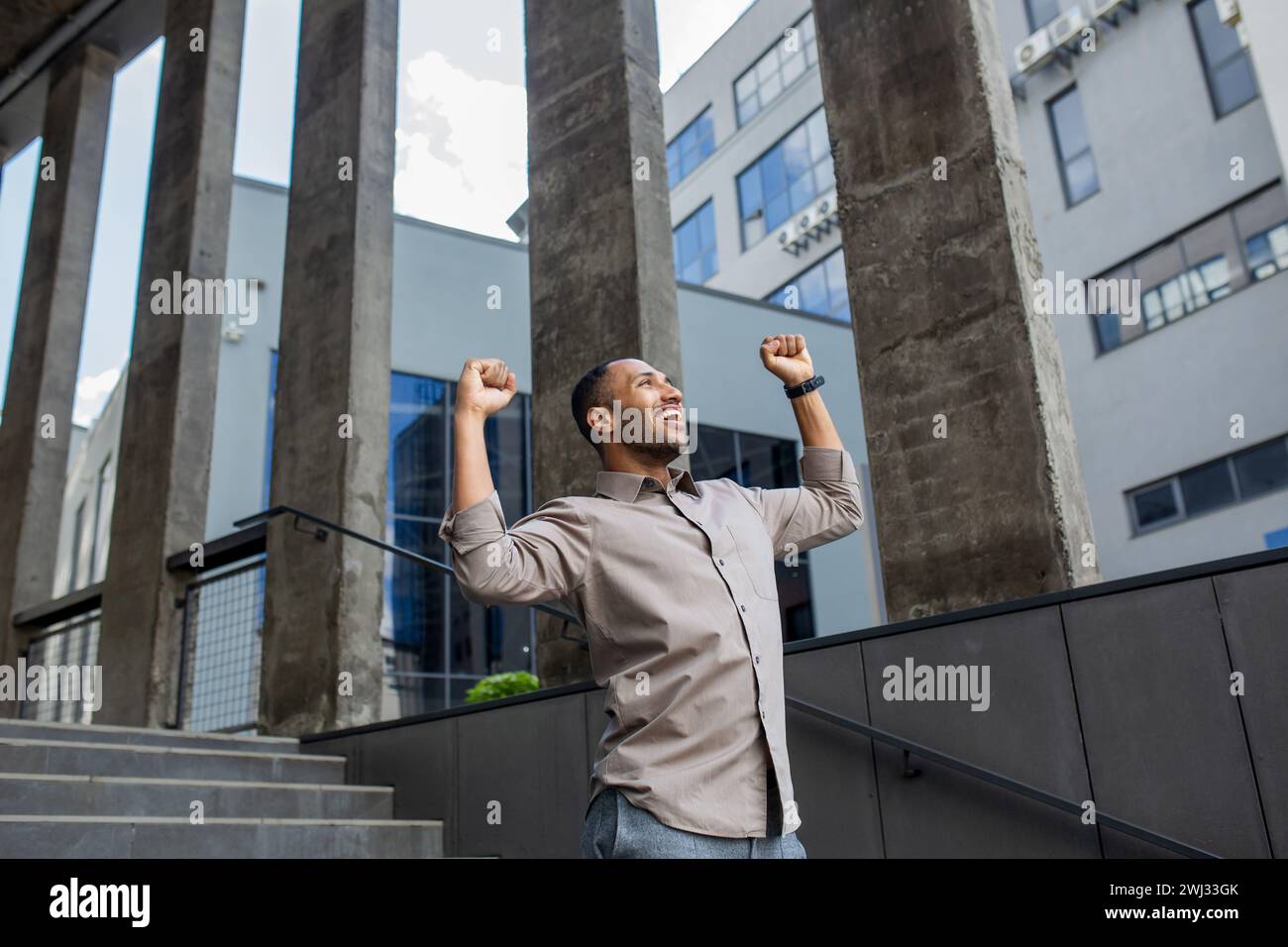Man raises arms stands hi-res stock photography and images - Alamy