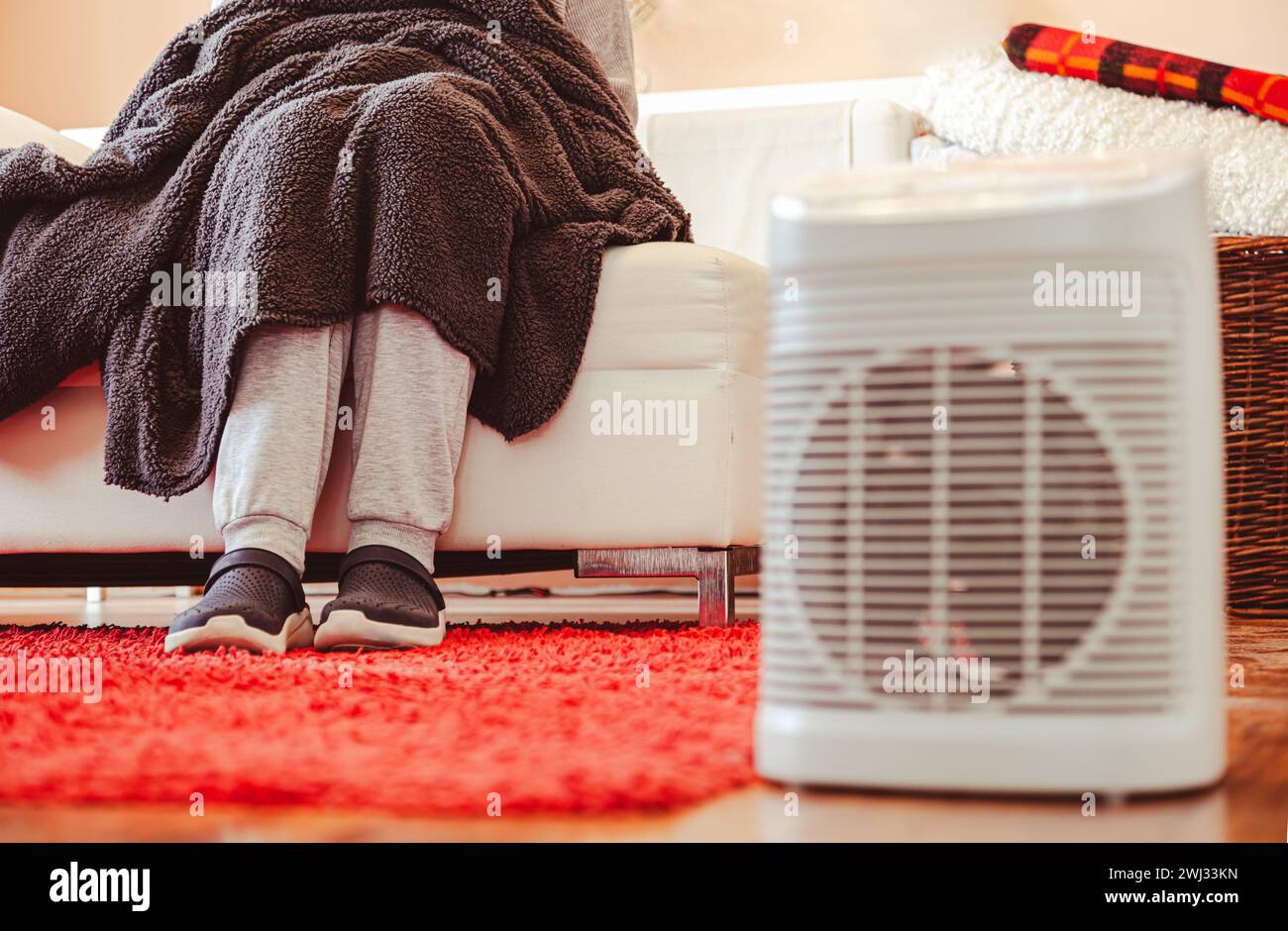 Heating season. feet in socks. woman feet with socks. Room heating with ...