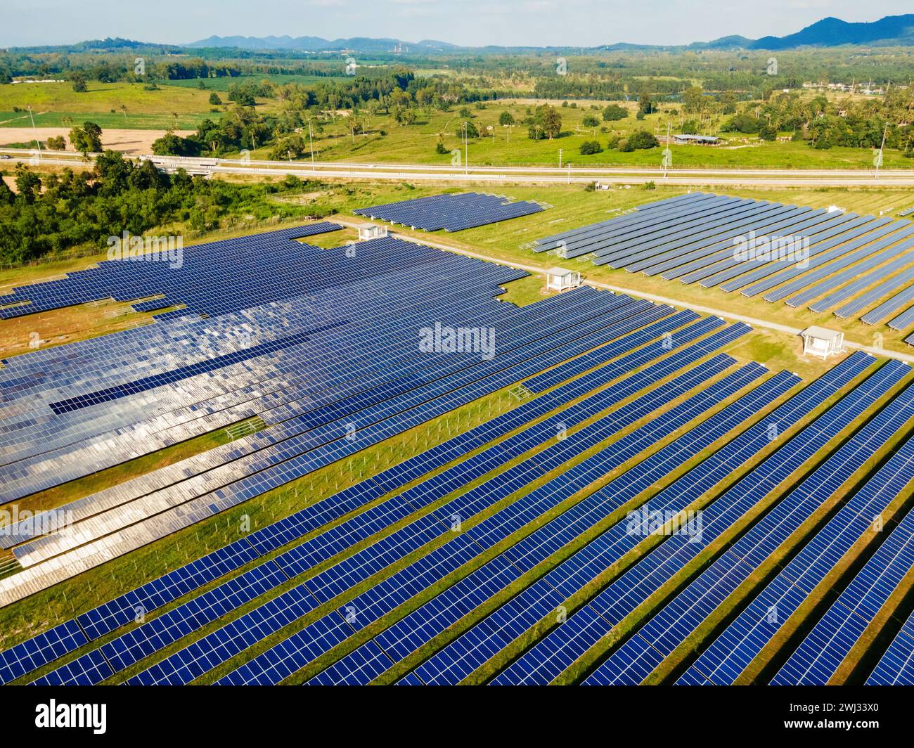 Solar panels sun power on the field in summer aerial view in Thailand ...