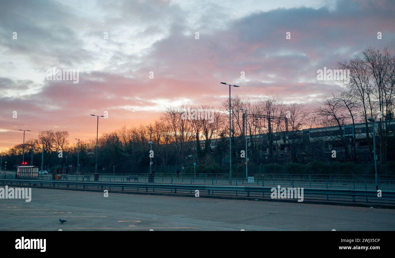 Early morning street view from Bus line to train track as it speeds ...